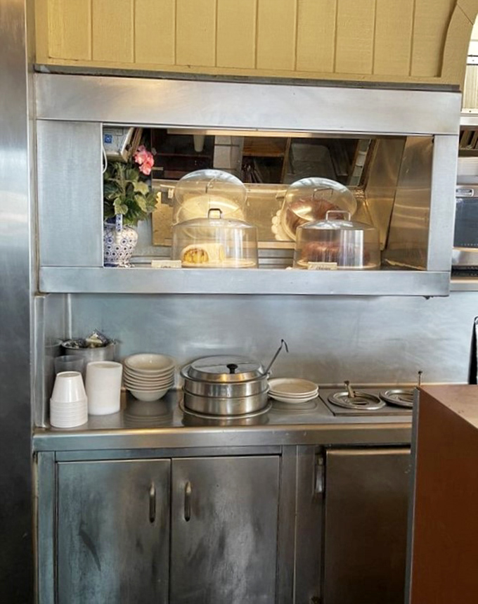 Behind the scenes, the kitchen pass-through offers glimpses of baked goods waiting patiently under glass domes&mdash;edible treasures guarded until the perfect moment.