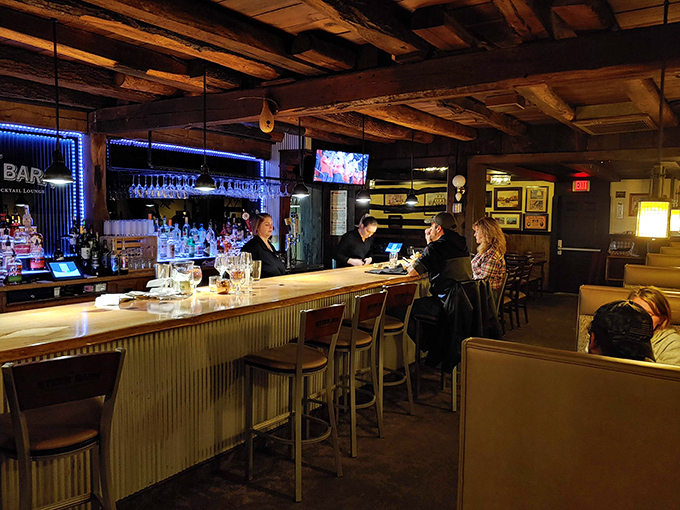 The bar area glows with amber promise &ndash; where old-fashioned cocktails meet old-fashioned hospitality under exposed wooden beams.