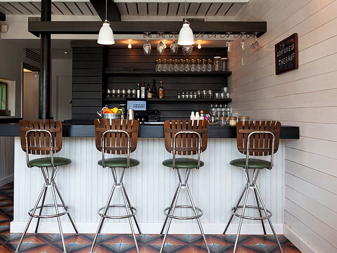 The bar area&mdash;where solo diners become regulars and regulars become friends. Those wooden barstools have heard countless stories of "the best seafood I've ever had."
