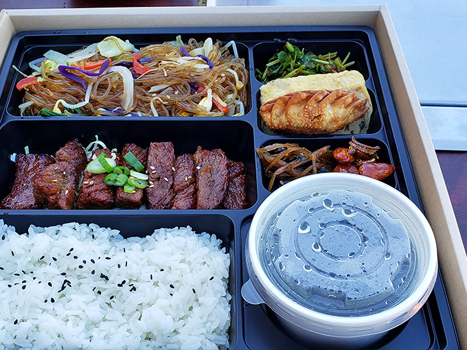 The bento box presentation proves that Korean BBQ travels well&mdash;bringing that tabletop grill experience to your home, office, or secret eating spot.