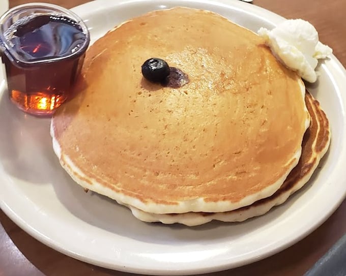 Pancakes so perfectly golden they belong in Fort Knox. That single blueberry is like the cherry on top, except it's a blueberry, and it's not on top.