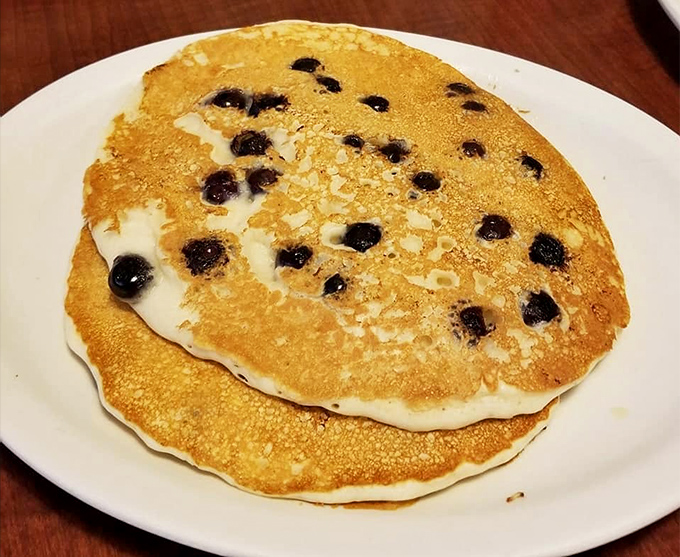 Blueberry pancakes that capture summer in every bite &ndash; golden discs studded with bursts of fruit that pop like tiny flavor bombs.