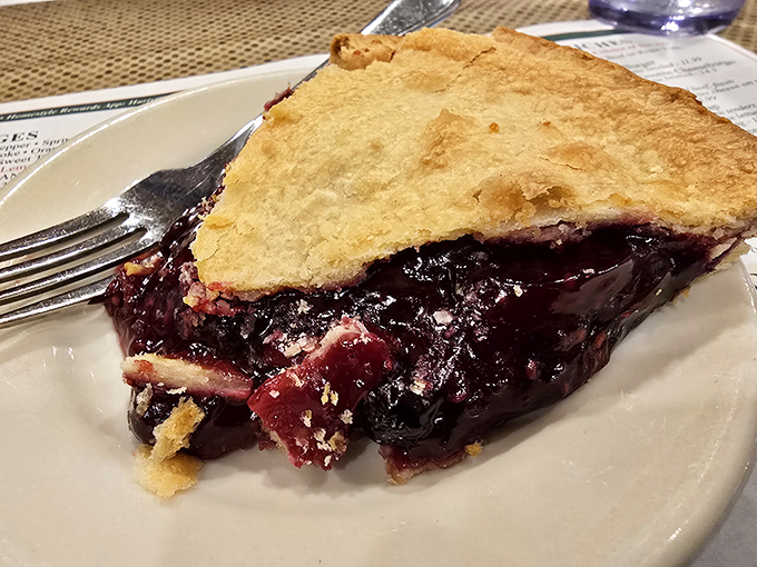 This slice of blueberry pie isn't just dessert&mdash;it's a purple-hued miracle with a buttery crust that makes you wonder why anyone bothers with birthday cake.