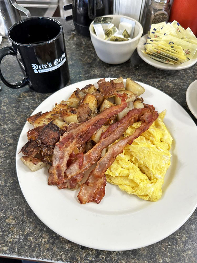 The holy trinity of breakfast: perfectly scrambled eggs, bacon with the ideal crisp-to-chew ratio, and home fries that could make a potato proud.