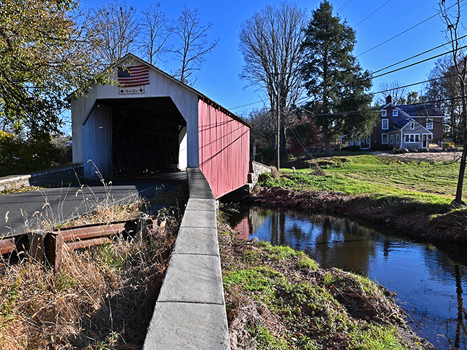 The perfect reflection of the bridge in the creek below creates a mirror image that doubles the visual impact of this architectural treasure.