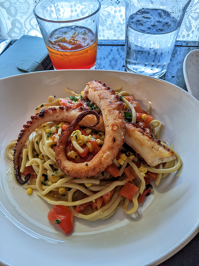 This bucatini with octopus is a masterclass in texture&mdash;tender tentacles meet al dente pasta in a summer vegetable symphony.