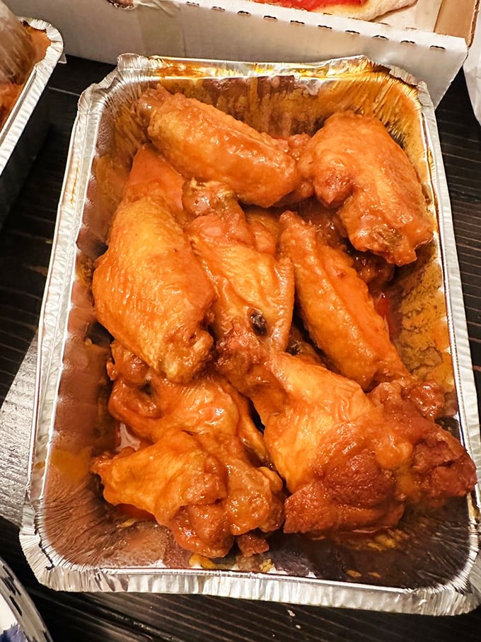 Buffalo wings glowing with that distinctive orange hue&mdash;nature's warning sign that says "delicious heat ahead." Your taste buds are about to tango.