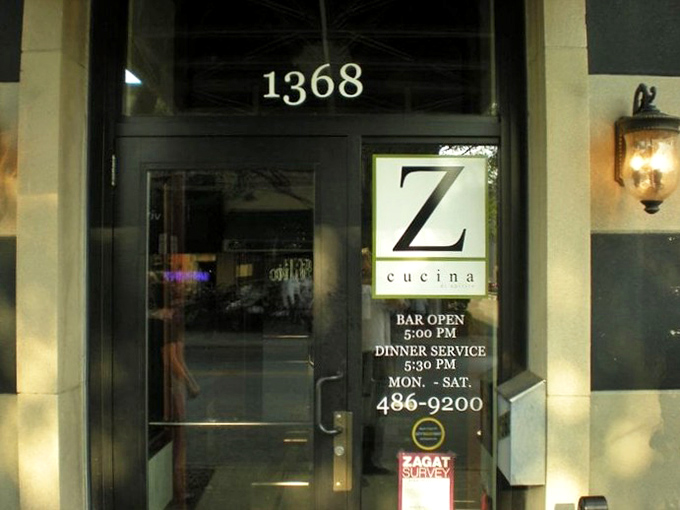 The entrance details reveal Z Cucina's commitment to hospitality—clear hours posted so you'll never miss your chance at those legendary short ribs.
