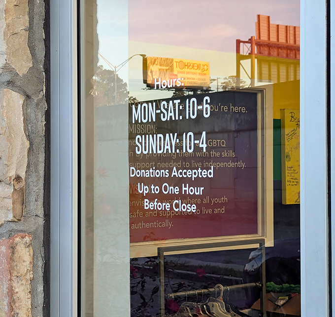 Hours posted clearly&mdash;a thrifter's roadmap to success. The golden sunset reflection seems to say, "Come back tomorrow for a whole new inventory adventure."
