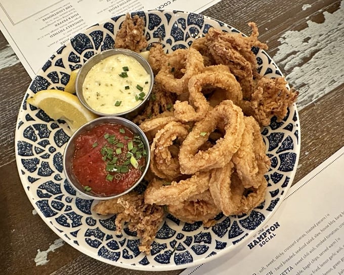 Calamari so perfectly golden and tender, served with two dipping sauces because sometimes life's biggest dilemma should be "which sauce first?"