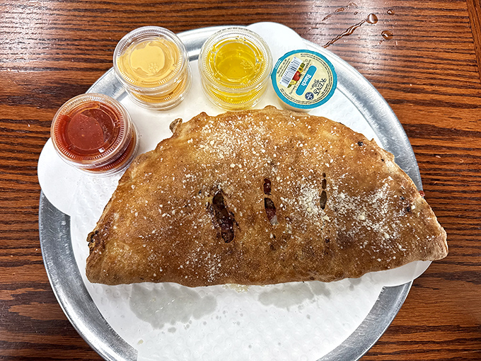 The calzone with dipping sauces &ndash; a half-moon of happiness that proves folded pizza might be pizza's perfect final form.