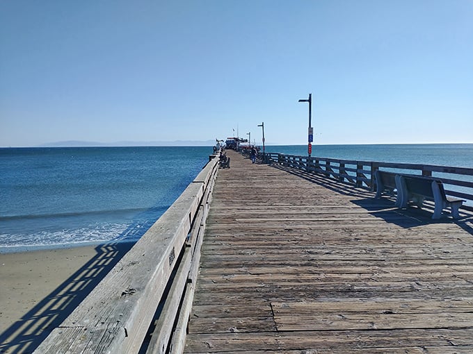 The wooden planks of Capitola Wharf lead visitors on a journey into the bay, where the horizon promises adventures and the shoreline beckons you home.