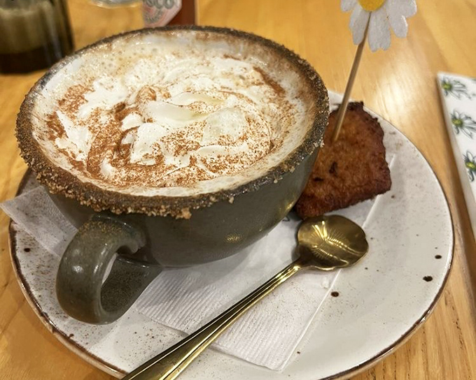 A cappuccino served with such artful foam and a tiny cookie sidekick that you almost feel guilty disturbing its perfection. Almost.