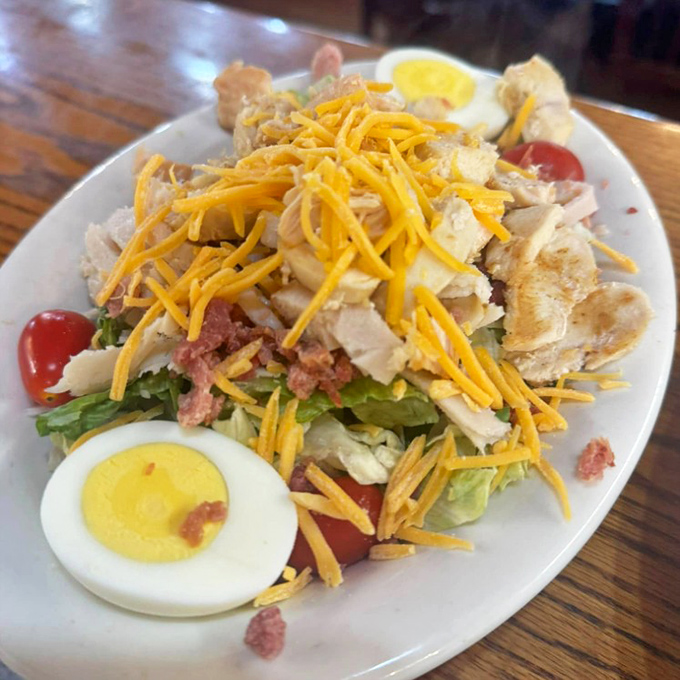 A chef salad that actually satisfies, proving vegetables can be exciting when properly introduced to cheese, eggs, and enough protein to fuel a small army.