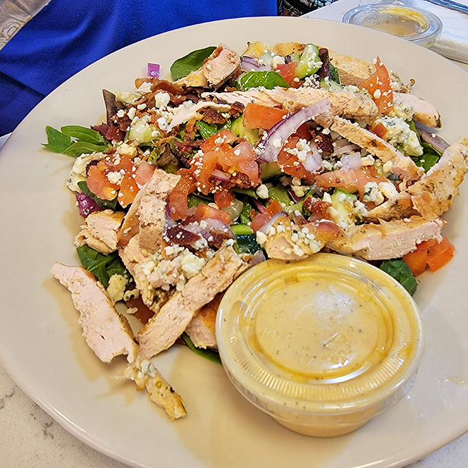 A salad that doesn't feel like punishment. Proof that healthy eating can coexist with actual flavor in the diner universe.