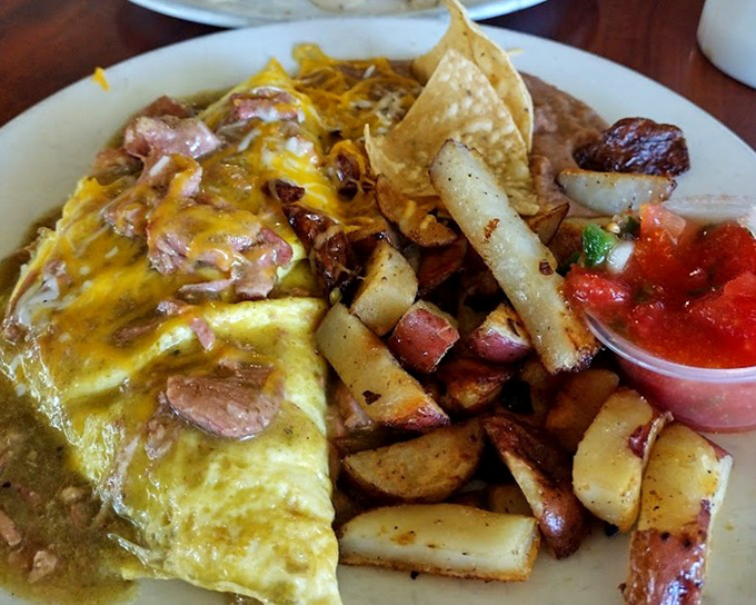 An omelet that's been thoroughly introduced to Chile Verde and decided to get married. This isn't just breakfast&mdash;it's a morning romance novel with cheese as the happy ending.