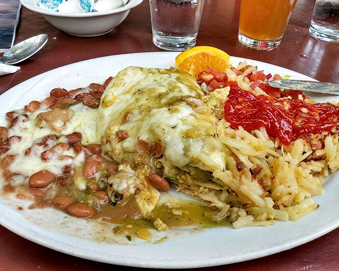 A burrito that refuses to be contained by mere tortilla boundaries. Those beans, rice, and verde sauce create a Southwestern symphony on a plate.