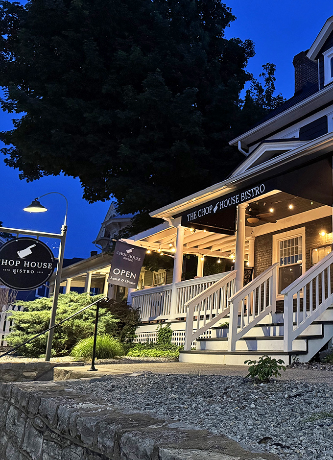 The Chop House Bistro glows with evening promise&mdash;where white railings and warm lights invite you to dinner conversations that outlast dessert.