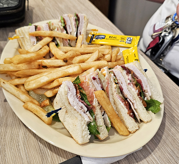 The club sandwich&mdash;architectural marvel of the lunch menu. Three layers of bread supporting the weight of expectations and delivering on every promise.