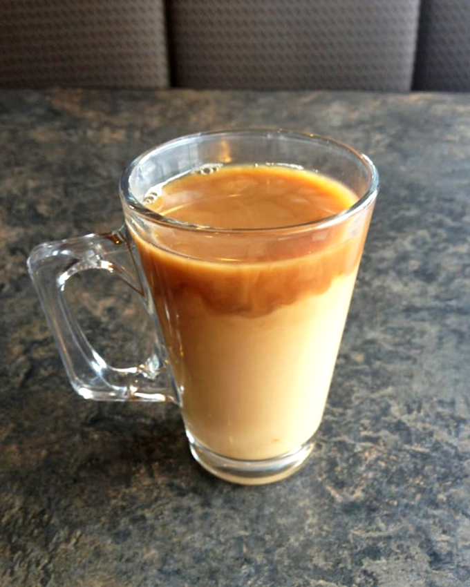 Coffee served in a glass mug&mdash;because when it looks this good, you deserve to watch the cream create mesmerizing swirls as it joins the party.