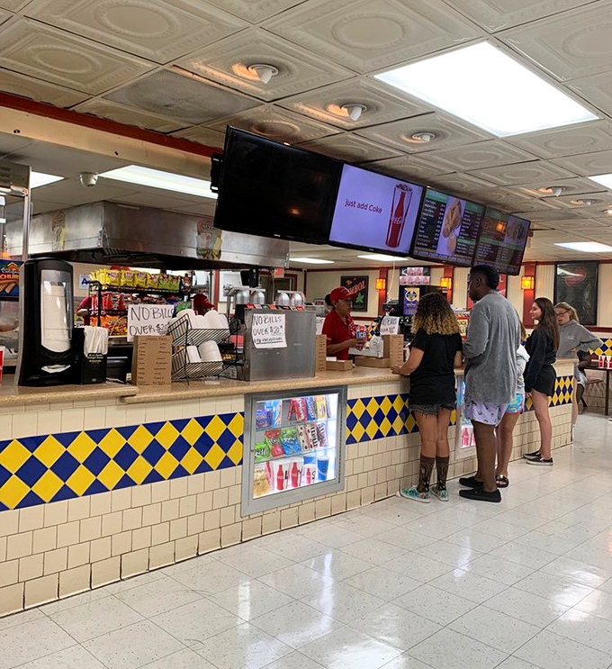 The concession counter where memories are made one nacho at a time&mdash;the yellow and blue tiles haven't changed since your parents brought you here.
