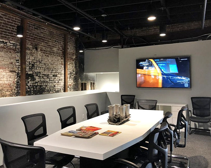 Beyond the showroom, the museum's conference space blends industrial brick with modern amenities&mdash;where car clubs and enthusiasts gather to share their mechanical passions.