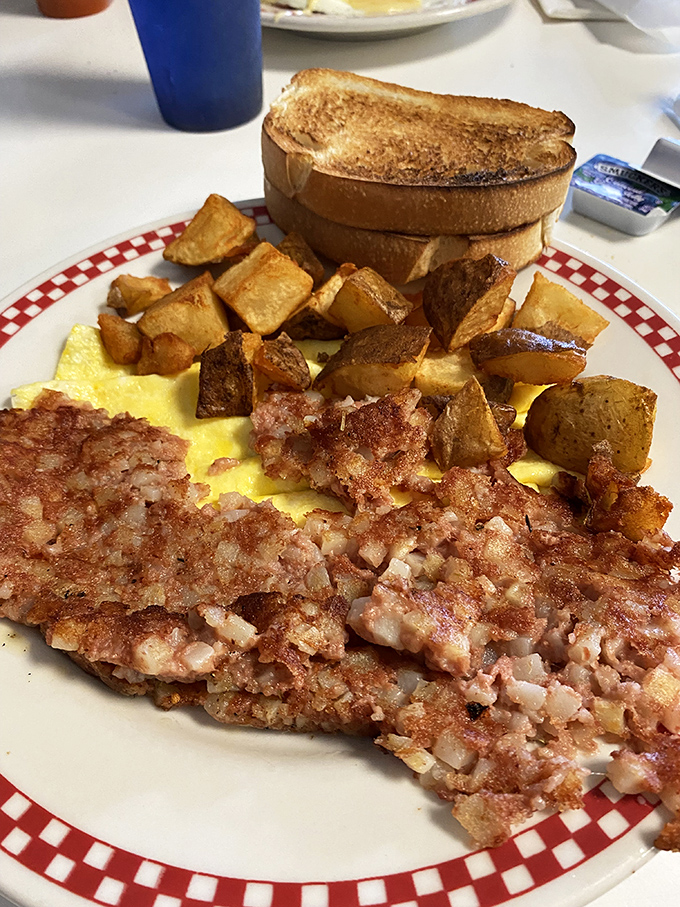 A breakfast plate that means business&mdash;crispy home fries, fluffy scrambled eggs, and what appears to be corned beef hash ready to fuel your Erie adventures.