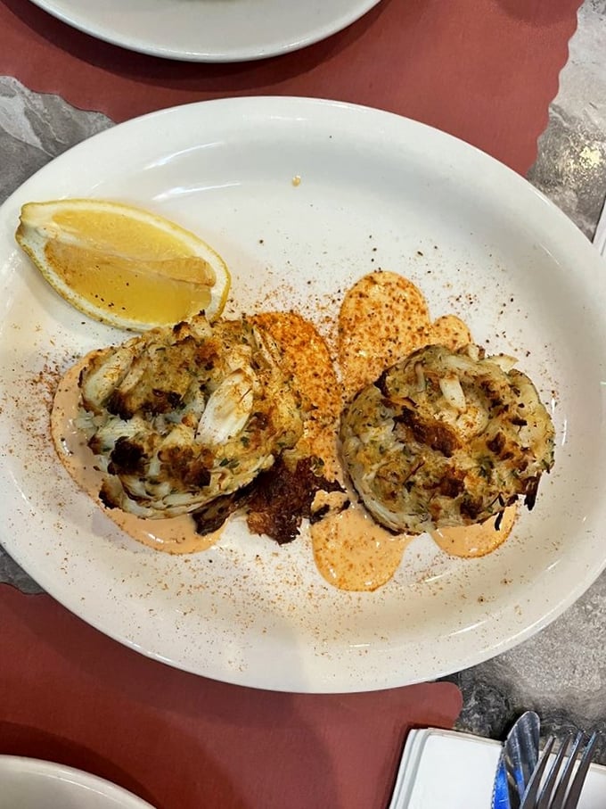 These crab cakes aren't just food; they're edible evidence that sometimes the simplest presentation showcases the most complex flavors.