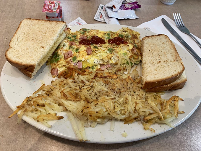 This Denver omelet with perfectly crispy hash browns is the breakfast equivalent of a warm hug. The toast stands ready for mopping duty.