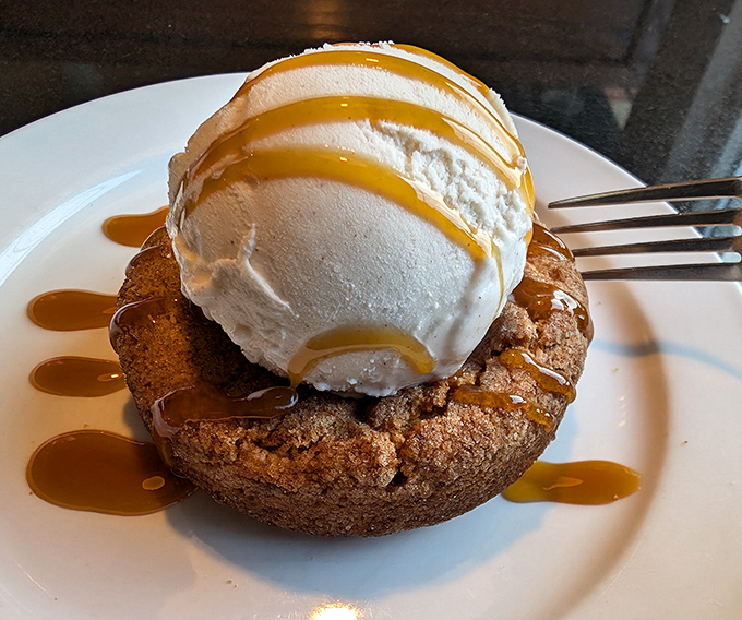 A cookie that's supporting the weight of ice cream and caramel like it's no big deal. Dessert architecture at its most deliciously precarious.