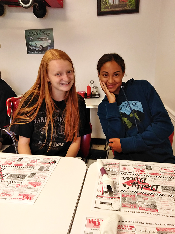 The image shows the diner's interior with vintage decor elements creating an atmosphere where conversations flow as freely as the coffee.