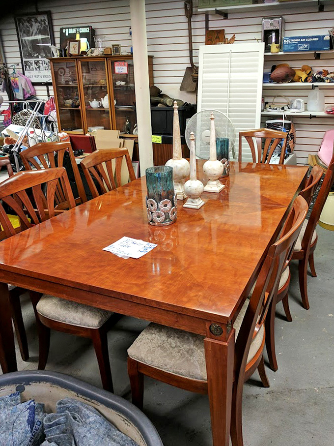Dining elegance amid the flea market chaos. This gleaming cherry wood table set awaits a family who appreciates both fine furniture and the thrill of secondhand discovery.