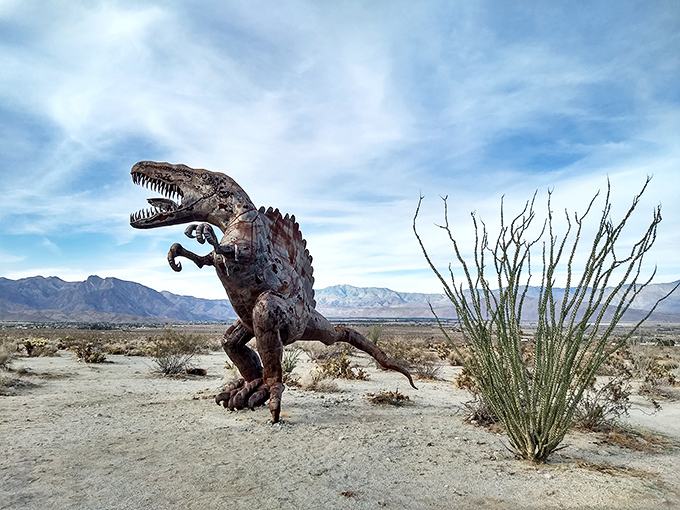 A dinosaur frozen mid-stride proves that even prehistoric predators appreciate good desert real estate with mountain views.
