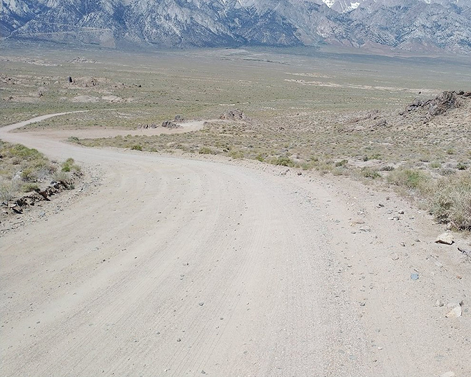 This humble dirt road delivers you to vistas that make paved highways seem like a waste of perfectly good asphalt.