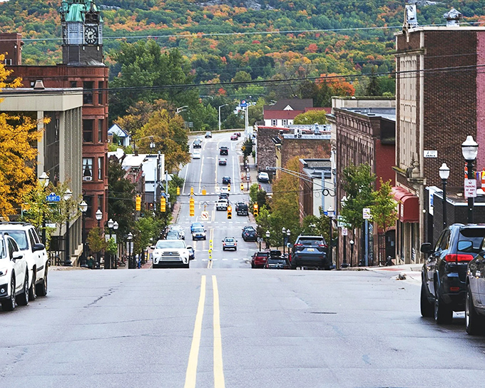 Autumn's golden light bathes downtown Marquette, where hills rise beyond the city streets, promising hiking trails and panoramic lake views.