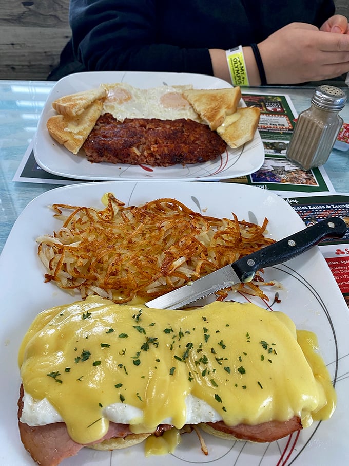 Eggs Benedict with a generous blanket of Hollandaise and crispy hash browns that could make a potato farmer weep with pride. Breakfast perfection on a plate.