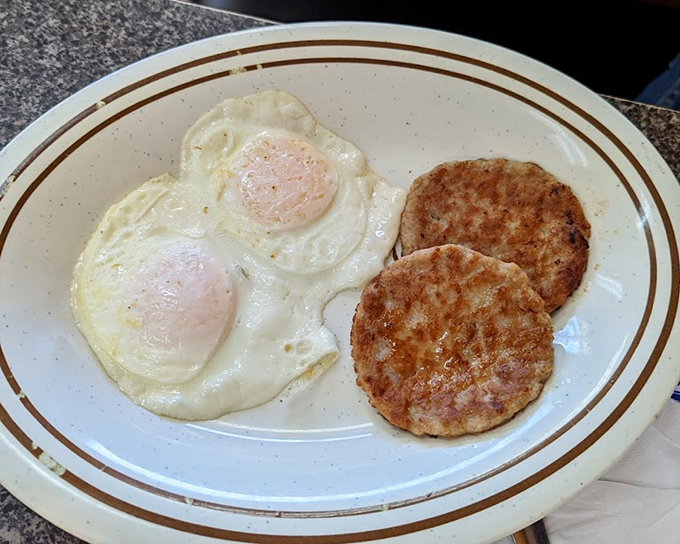 Two eggs with sausage patties - the breakfast that launched a thousand productive days. Sometimes simplicity is the ultimate sophistication.