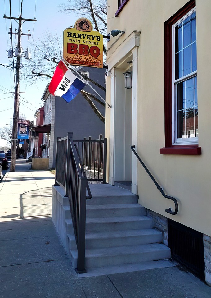 The iconic sign beckons hungry travelers like a barbecue lighthouse guiding ships through a sea of mediocre dining options.