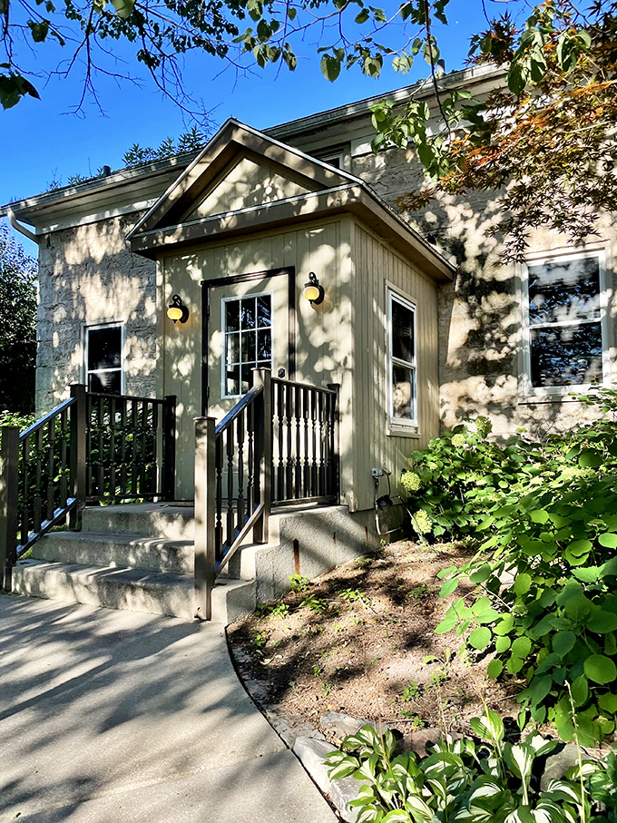 Dappled sunlight plays across the entrance, creating the perfect transition from everyday world to the culinary escape waiting inside.