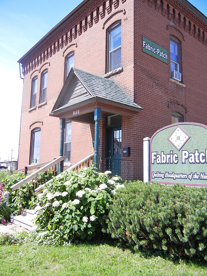 The Fabric Patch occupies a classic brick building where quilting enthusiasts find their happy place among bolts of possibility.
