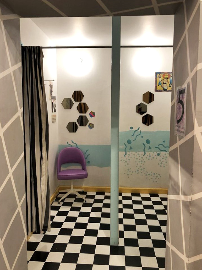The fitting room—where '80s dreams are either realized or gently redirected, complete with checkered floors straight out of an MTV video set.