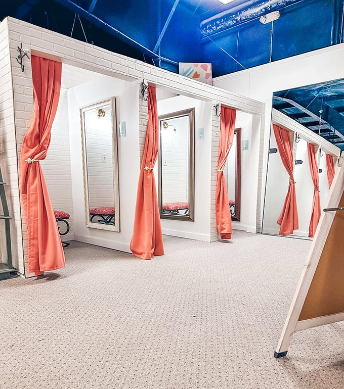 Fitting rooms that respect your dignity! These coral curtains and full-length mirrors create a boutique experience that big-box retailers can't match.
