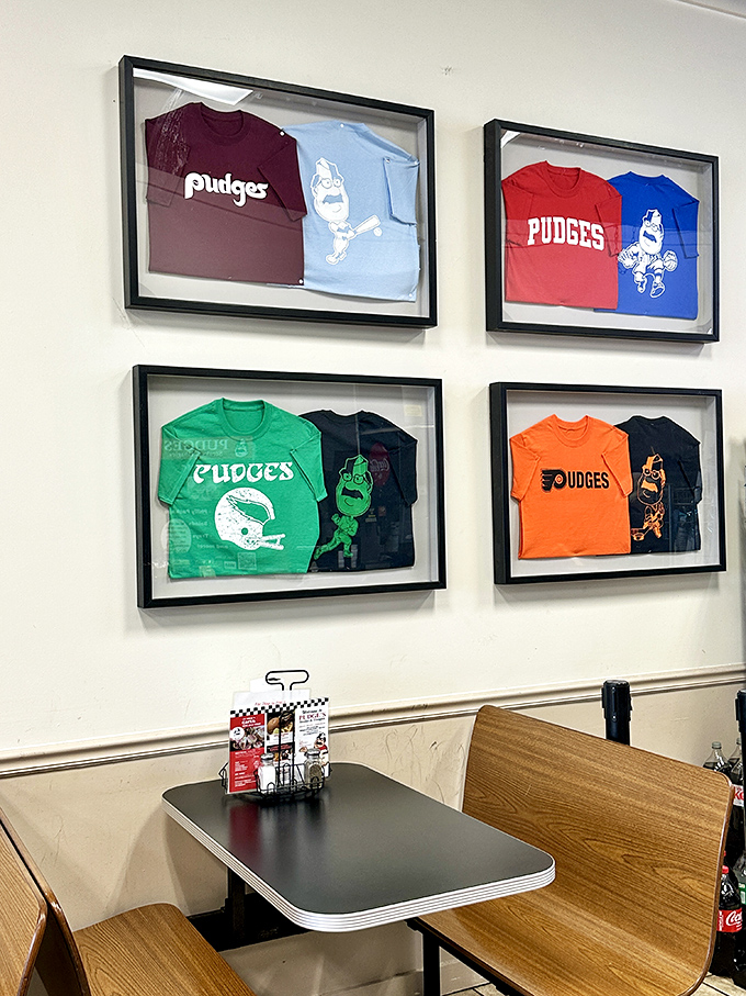 Framed t-shirts on display like the sandwich hall of fame they are. Even the merchandise celebrates the mustachioed mascot who oversees this temple of taste.