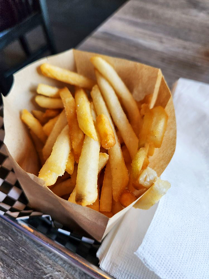 French fries in their paper cocoon, golden and glistening. The supporting actor that sometimes steals the show from the burger headliner.
