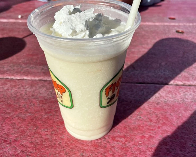 Their frozen piña colada isn't just a drink—it's a vacation in a cup. Topped with whipped cream and sporting the Fish Camp logo, it's the perfect finale to a seafood feast.