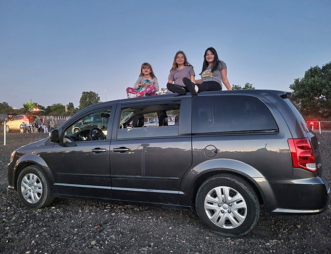 The roof of the family van becomes prime seating for these young moviegoers&mdash;creating memories that will outlast whatever's playing on screen tonight.
