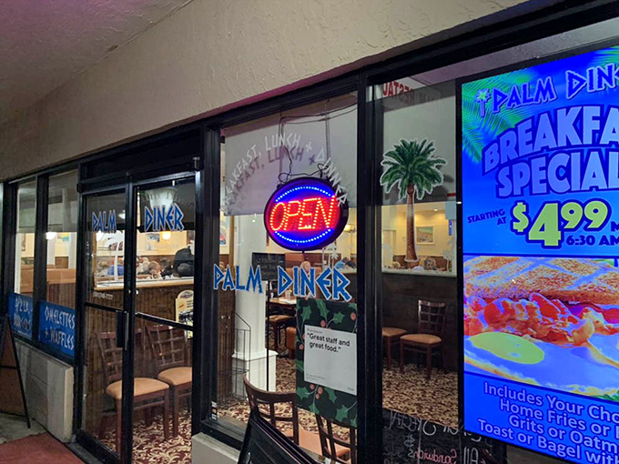 The glowing "OPEN" sign&mdash;three universal letters that translate to "come in, sit down, and forget your troubles." Breakfast specials are just a bonus.