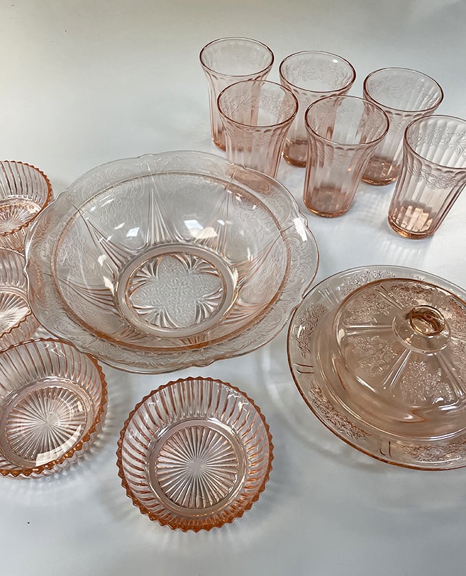 Depression glass treasures in delicate pink&mdash;these aren't just dishes, they're time machines to grandmother's Sunday dinner table.