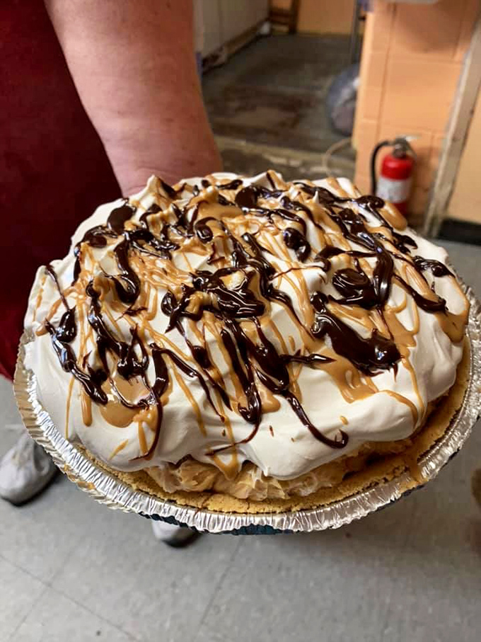 This isn't just pie; it's an architectural masterpiece of cream, caramel, and chocolate that makes you reconsider what happiness truly means.