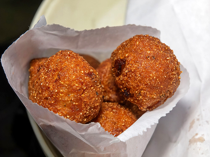Hush puppies so perfectly golden they look like edible treasure. These crispy cornmeal spheres are the supporting actors that steal the show.